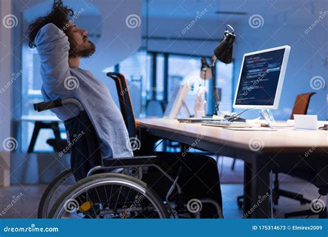 Disabled Web Developer In The Wheelchair Works In The Office At The