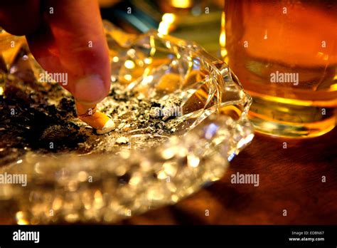 A Man Stubbing Out A Cigerette Stock Photo Alamy