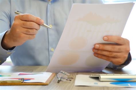 Premium Photo Businessman Analyzing Business Graphs On The Office Desk