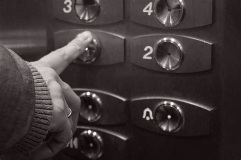 리프트 버튼에 손가락 흑백 엘리베이터 버튼을 만지는 여자 엘리베이터의 레벨 선택 층 번호 패널 현대적인 엘리베이터 인테리어