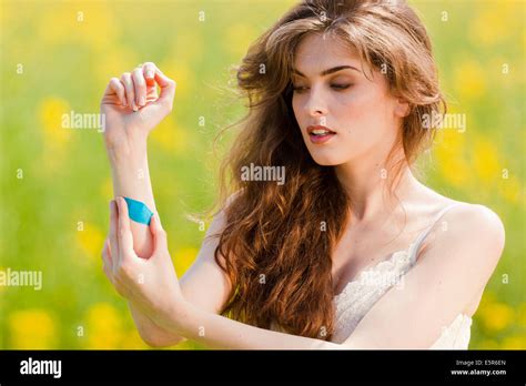 Woman Putting A Band Aid On Arm Stock Photo Alamy