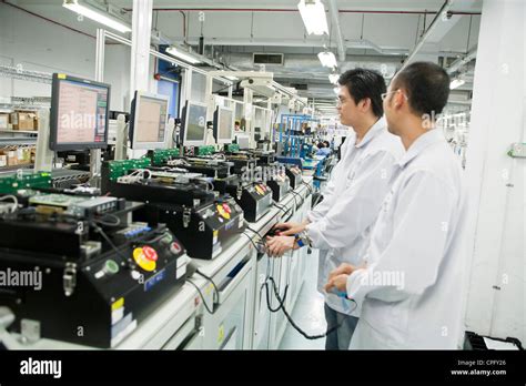 Workers Assemble Hand Held Inventory Computer Devices On The Assembly