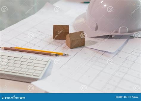 Structural Engineer And Architect Desk With Safety Helmet Blueprint And Model House Stock Image