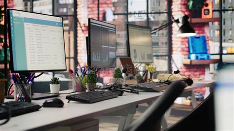 Computer Monitors In Empty Office Displaying Analytics Dashboards Stock