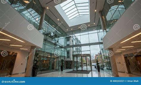 Modern Atrium With Wooden Ceiling And Lush Planters Inside Office