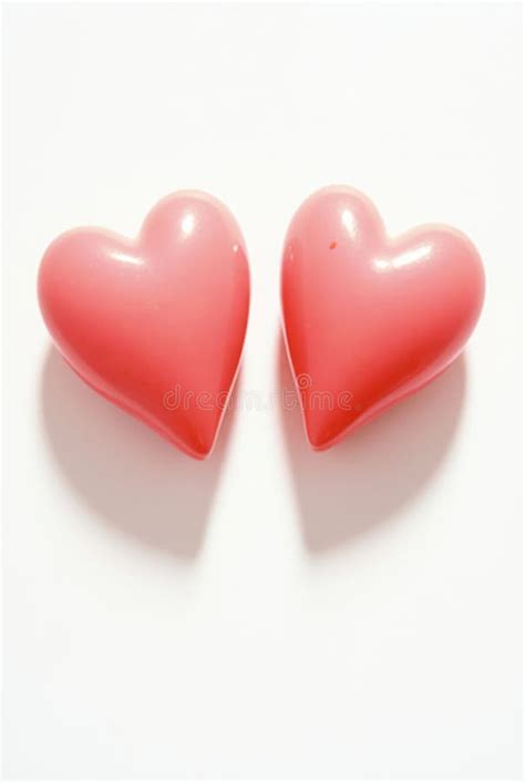 Two Identical Red Hearts Placed Symmetrically Side By Side On A White