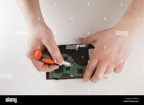 The Computer Hard Drive In The Course Of Dismantling On A White Background Stock Photo Alamy