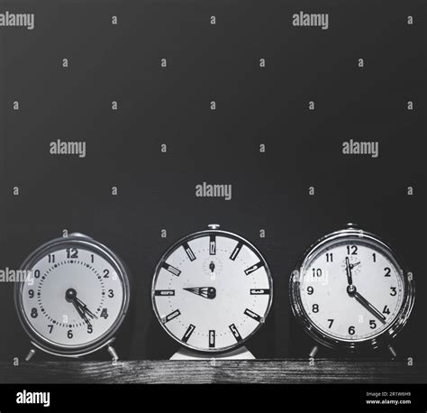 A Black And White Image Of Three Classic Circle Shaped Analog Clocks