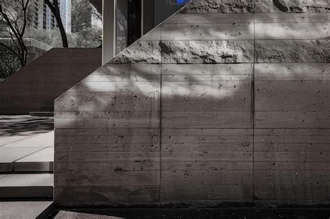 A Large Concrete Wall With A Tree On It Premium AI Generated Image