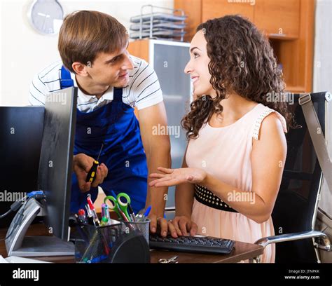 Cheerful Technical Support Engineer Doing Malfunction Diagnosis Of Client Computer At Home