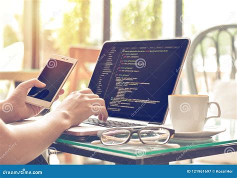 A Female Programmer Typing Source Codes And Using Mobile Phone In A