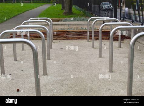 A photo of a group of bike parking metal racks lined up together on a path Stock Photo - Alamy