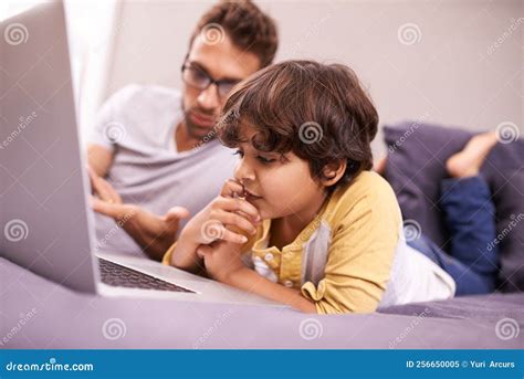 Lets Play The Guessing Game A Father And Son Using A Laptop While