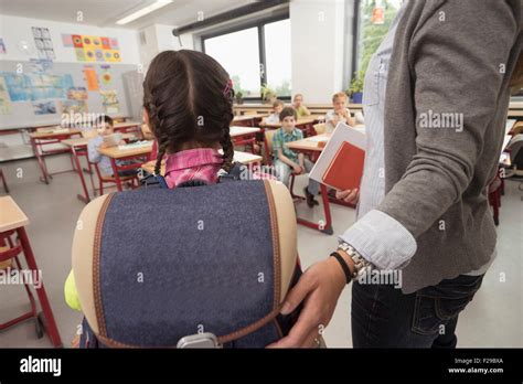 Female Teacher Introducing A New Classmate In Classroom Munich