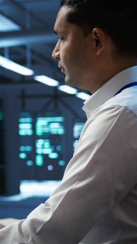 Vertical Portrait Of Smiling Technician In Data Center Implementing And Managing Infrastructure