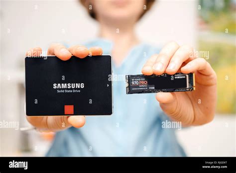 Woman Hands Holding New NVME PCIE SSD Hard Drive Disk With High Read And Write Speed Comparing