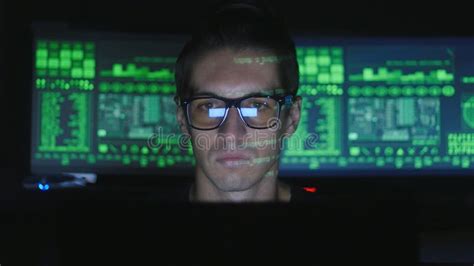 hacker programmer in glasses is working on computer in cyber security