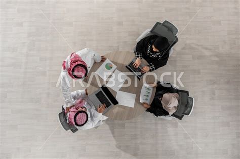 A Work Meeting To Discuss And Organize Tasks A Vertical Overhead Portrait Of A Saudi Gulf Arab