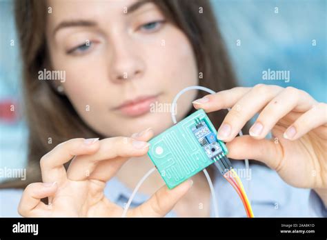 Young Scientist Woman In Microbiological Lab With Lab On Chip Loc Microfluidic Device Stock