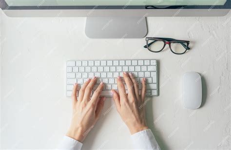 premium photo top view on typing hands on a computer keyboard of a