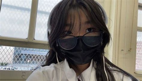 A Woman Wearing Sunglasses And A Black Mask