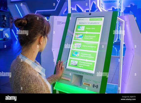 Woman Using Interactive Touchscreen Green Kiosk At Modern Museum Or Exhibition Stock Photo Alamy