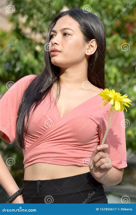 Unemotional Beautiful Filipina Adult Female With A Daisy Stock Image