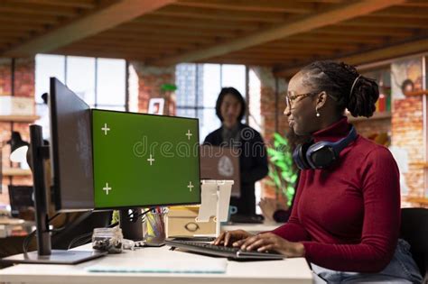 woman using chroma key computer to develop ai systems stock image