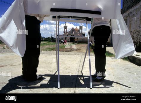 A Man And A Woman Cast Ballots In A Portable Voting Booth During