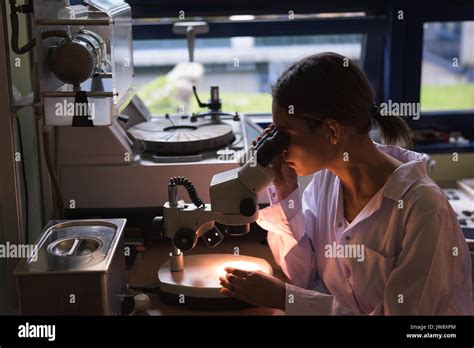 Female College Student Using Microscope While Practicing Experiment In Lab Stock Photo Alamy