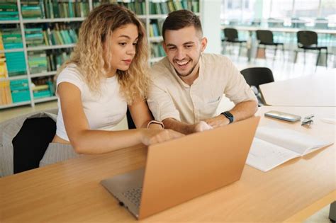 Premium Photo Two Classmate Look Into Laptop And Laugh Boy And Girl
