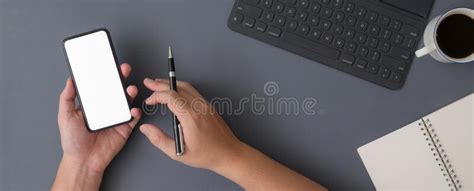 Overhead Shot Of Businessman Using Mock Up Smartphone While Working With Digital Tablet And