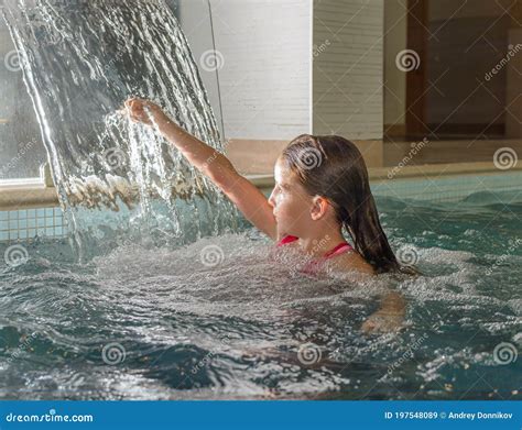 Young Beautiful Girl In Thermal Bath Relax Under Flowing Water Stream Of Shower Stock Image