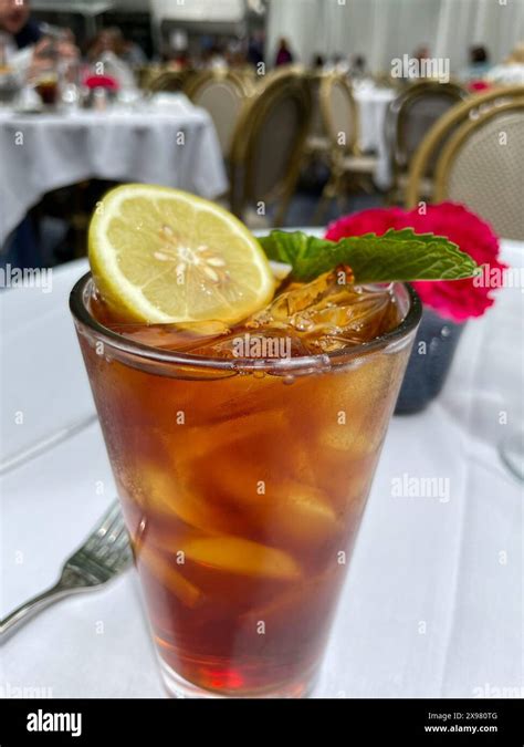 Tall Glass Of Iced Tea On A Table In The Outdoor Dining Garden At