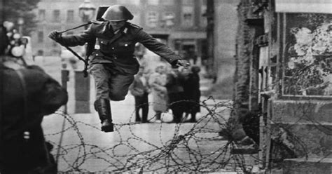Conrad Schumann An East German Soldier Jumping Over The Berlin Wall And Defecting To West