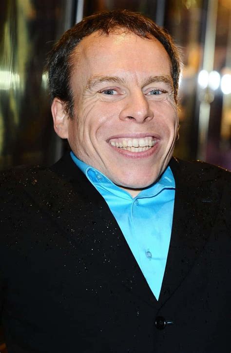 Download Warwick Davis Poses In A Stylish Photo Shoot Wallpaper