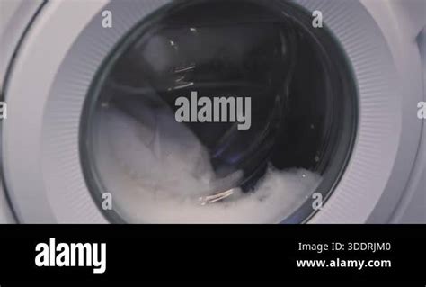 The Drum Of A Washing Machine Spinning During The Wash Cycle Laundry Spins With Water And Suds