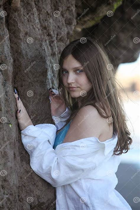 Pretty Girl In Bikini And White Shirt Leaning Against Y The Sea Cliff