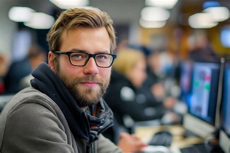 A Man In Glasses Sitting At A Computer Premium Ai Generated Image