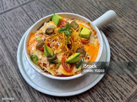 토르티야 가루 다진 쇠고기 모짜렐라 치즈 치즈 화이트 체다 토마토 체리 아보카도 피켈 할라피뇨 피클렐 부추 요구르트를 곁들인 맛있는 엔칠라다 음식 메뉴 0명에 대한 스톡