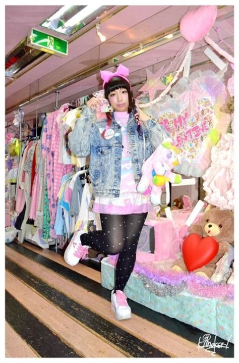 A Woman Standing In Front Of A Display Of Clothes And Teddy Bears At A