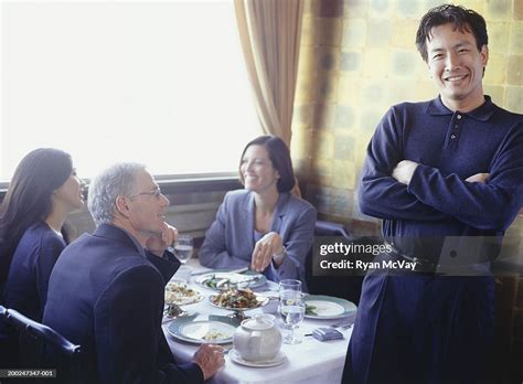 Two Couples Having Dinner In Restaurant One Man Standing Stock Foto Getty Images
