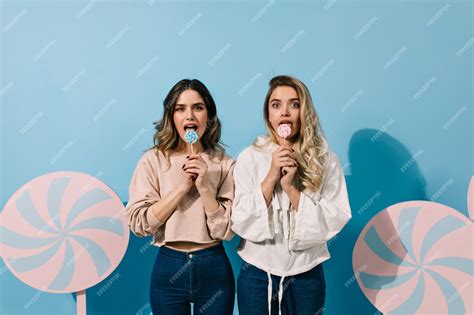 Free Photo Beautiful Young Ladies Licking Lollipops