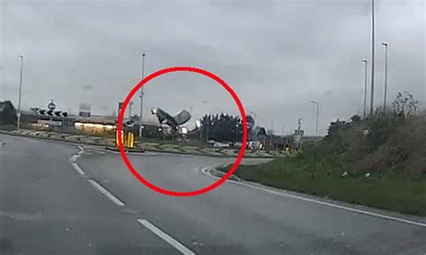 Shocking Moment Car Flies Over Roundabout Before It Crashes On The Other Side As Driver