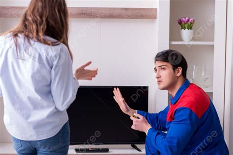 Tv Repairman Technician Repairing Tv At Home Photo Background And