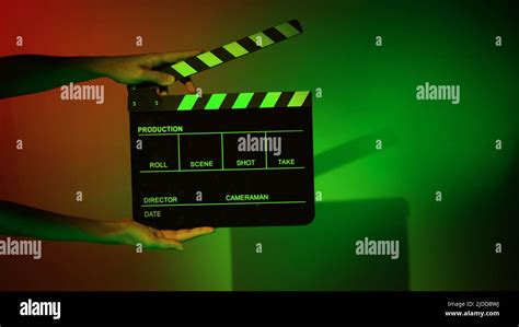 Movie Clapper Board Crew Hand Holding Plastic And Wooden Film Slate Board Against Camera Movie