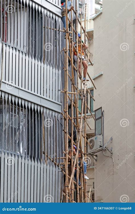 Workers Climbing Bamboo Scaffolding On A Modern Building Showcasing