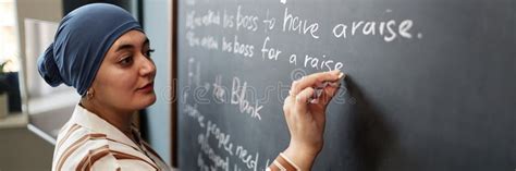 Header Image Of Female Muslim Student Writing On Blackboard Studying