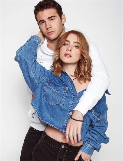 A Man And Woman Are Posing For The Camera With Their Arms Around Each Other S Shoulders