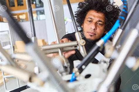 Engineer Programming A Robotic Gripper Arm For Industrial Automation In A Modern Laboratory